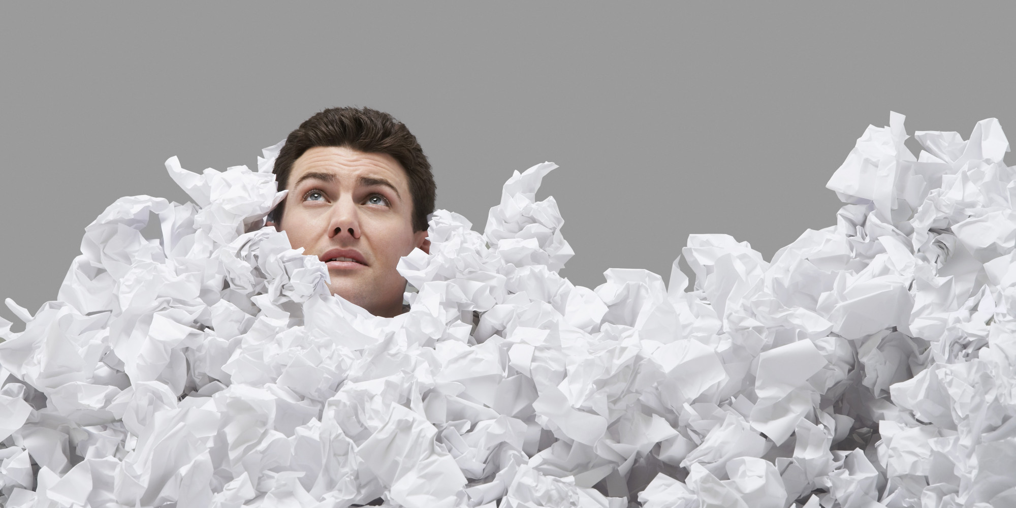 Woman Buried Under Paper